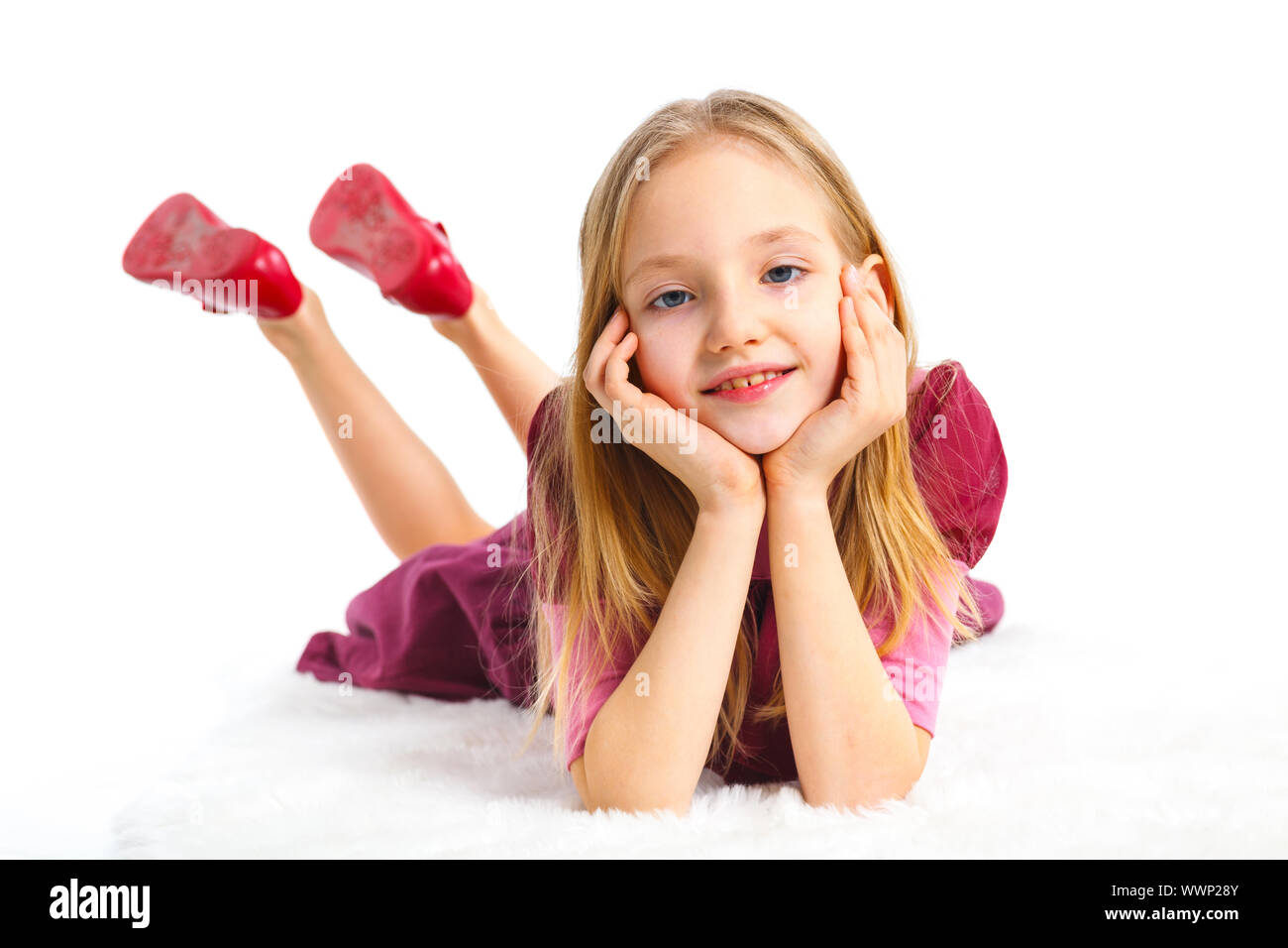 Happy girl lying on floor, isolated on white Stock Photo - Alamy