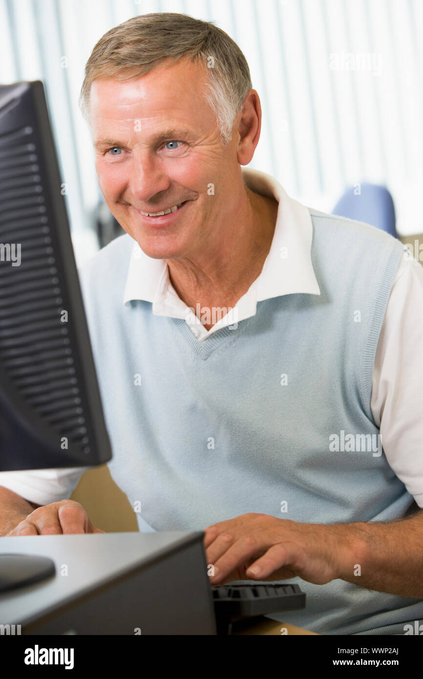 Man sitting at a computer terminal (high key Stock Photo - Alamy