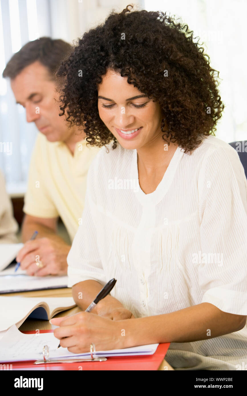Adult students studying at table (selective focus Stock Photo - Alamy