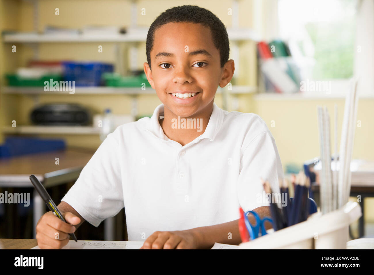 Student in class taking notes Stock Photo - Alamy