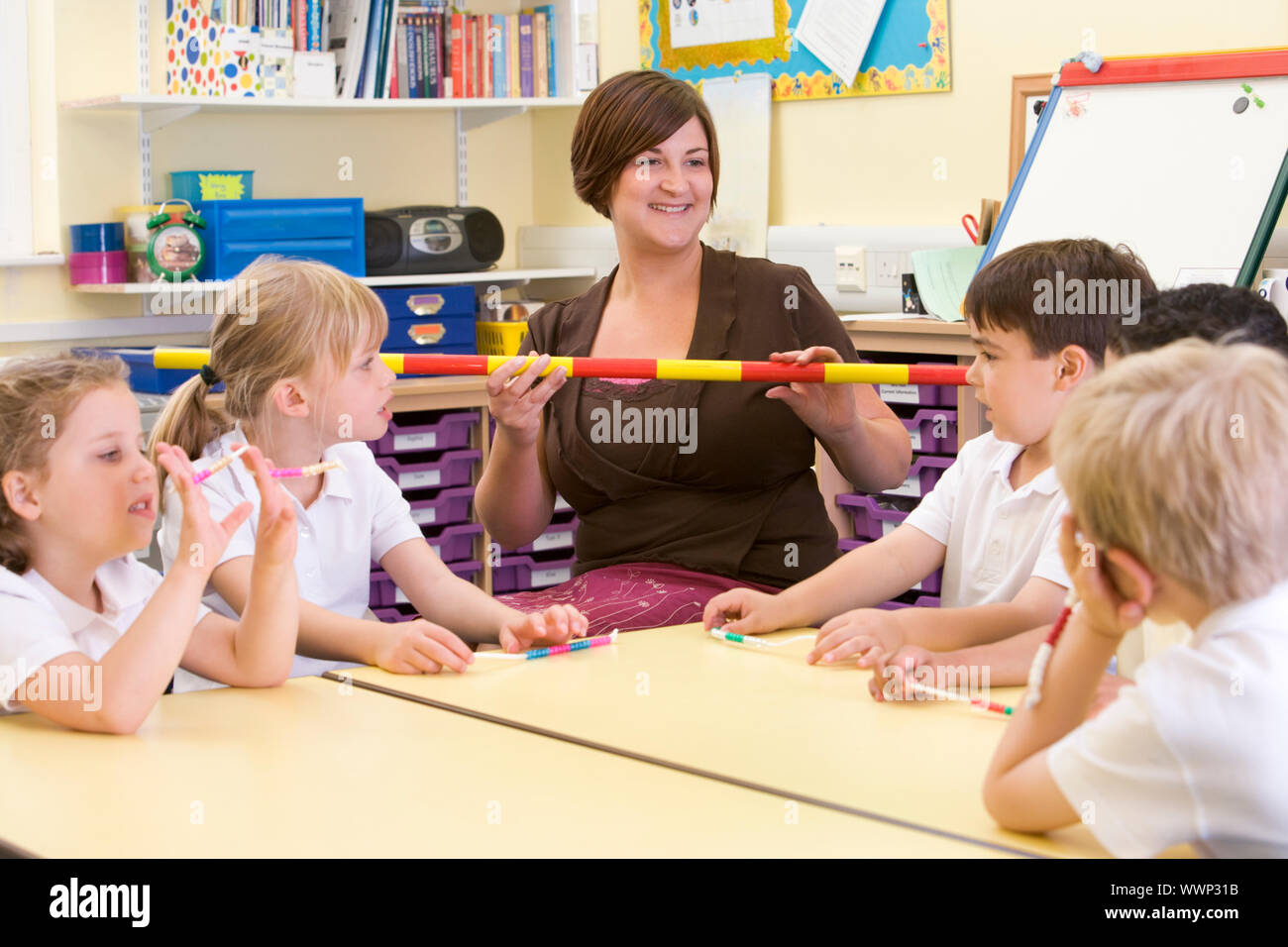 Teacher and students in math class with measuring stick Stock Photo - Alamy