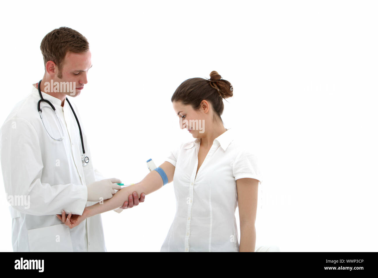 Doctor giving intravenous injection in the arm of a female patient or ...