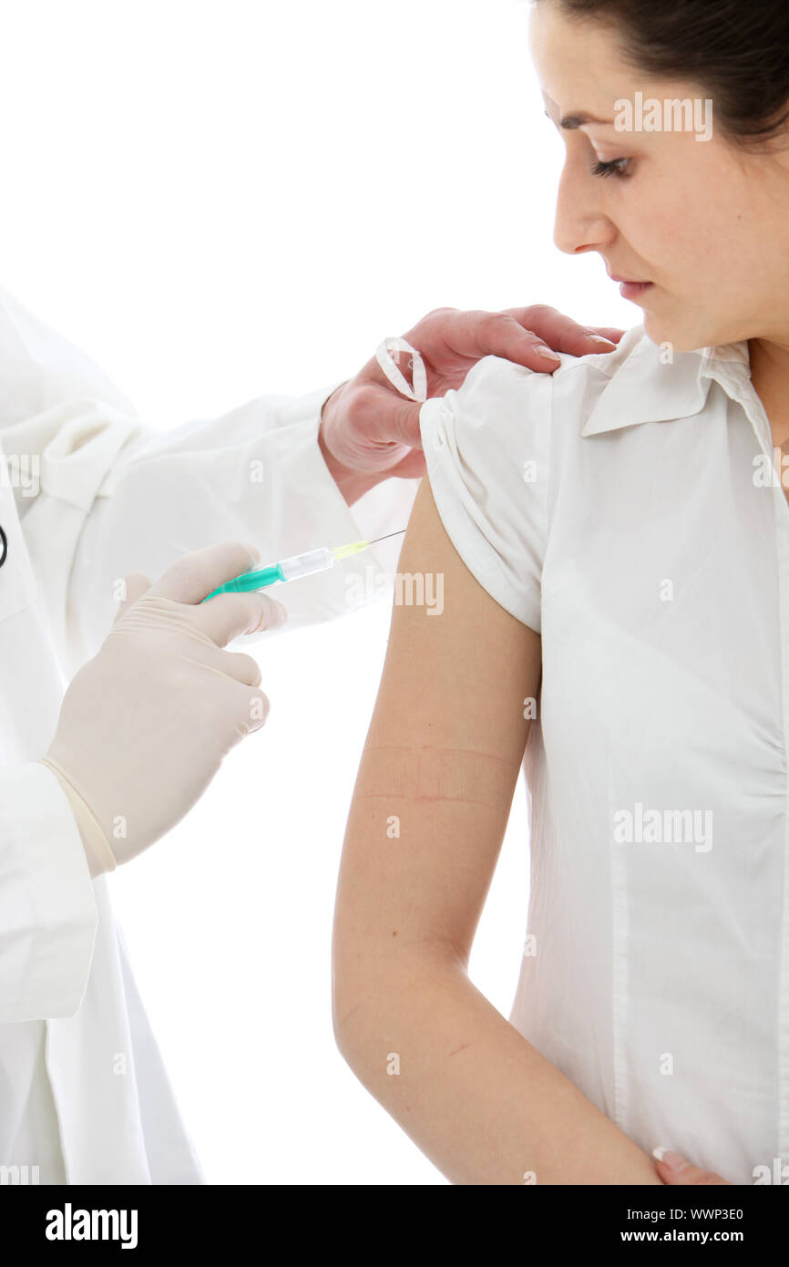 Female patient receiving an intramuscular injection in her upper arm ...