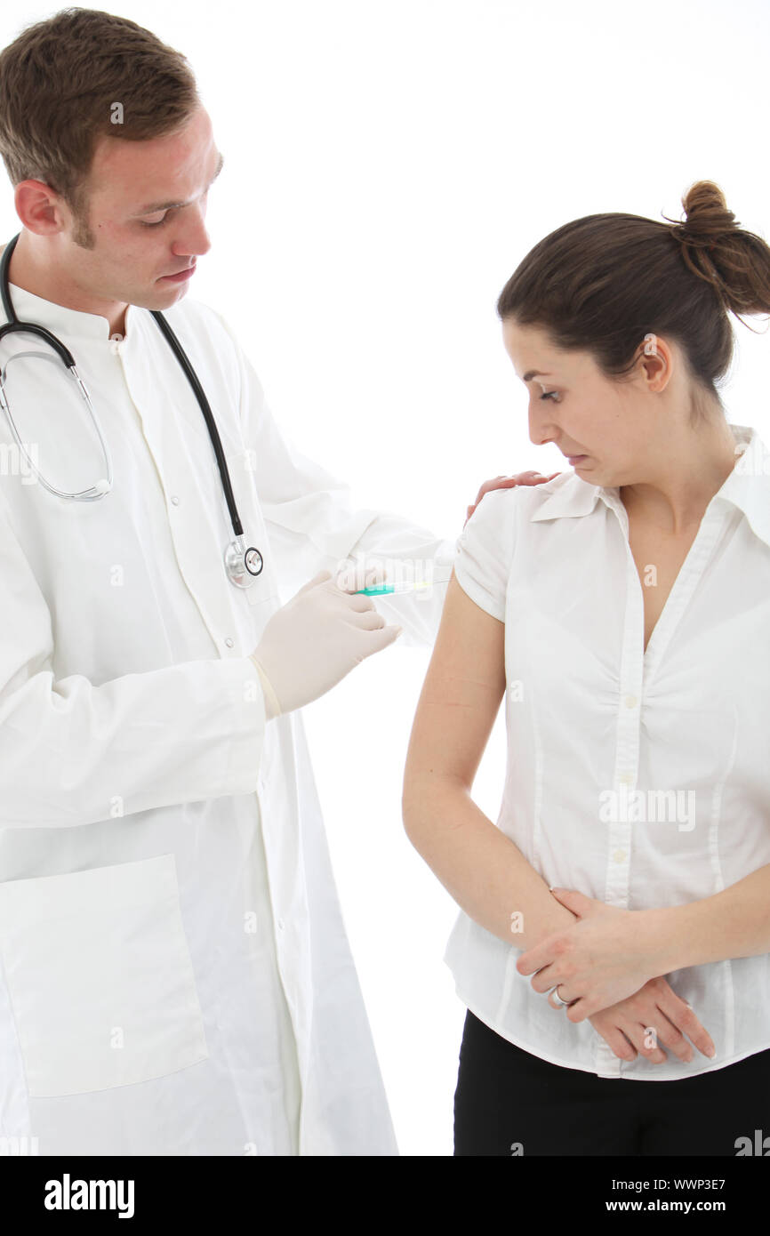 Woman grimacing as she receives an intramuscular injection in her upper ...
