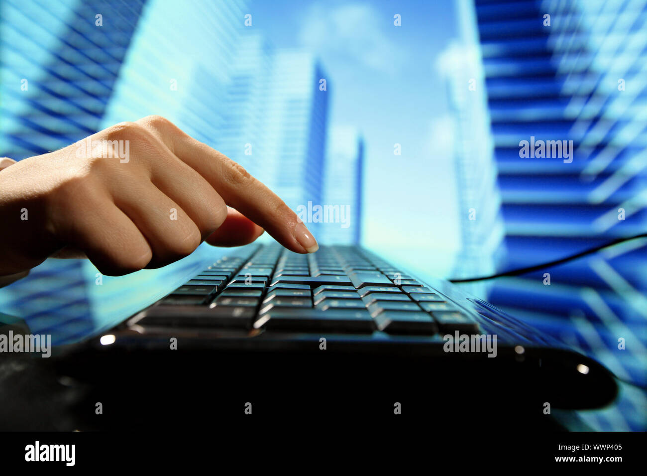 reseller work on keyboard skyscrapers on background Stock Photo - Alamy