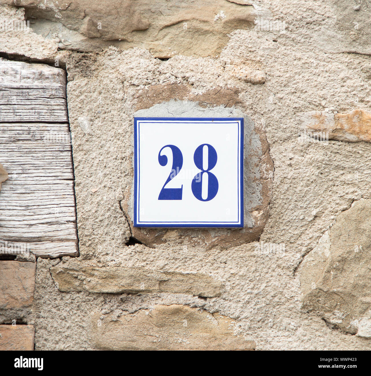 Ceramic number twenty eight on the grey stone wall Stock Photo - Alamy