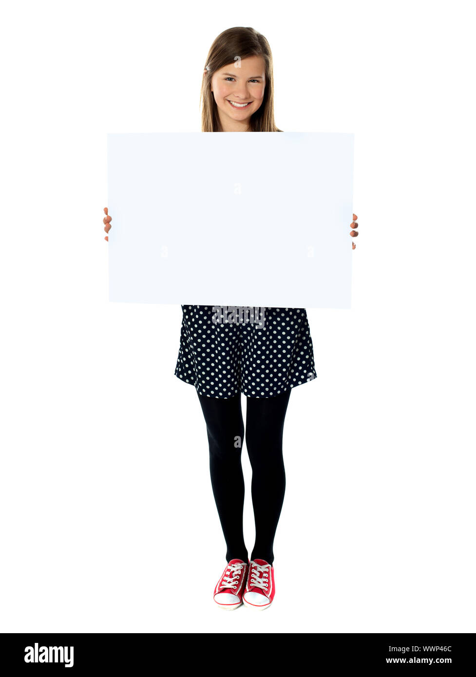 Attractive smiling cute girl holding blank poster against white ...