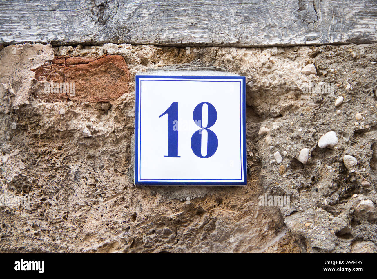 Ceramic number eighteen on the grey stone wall Stock Photo - Alamy
