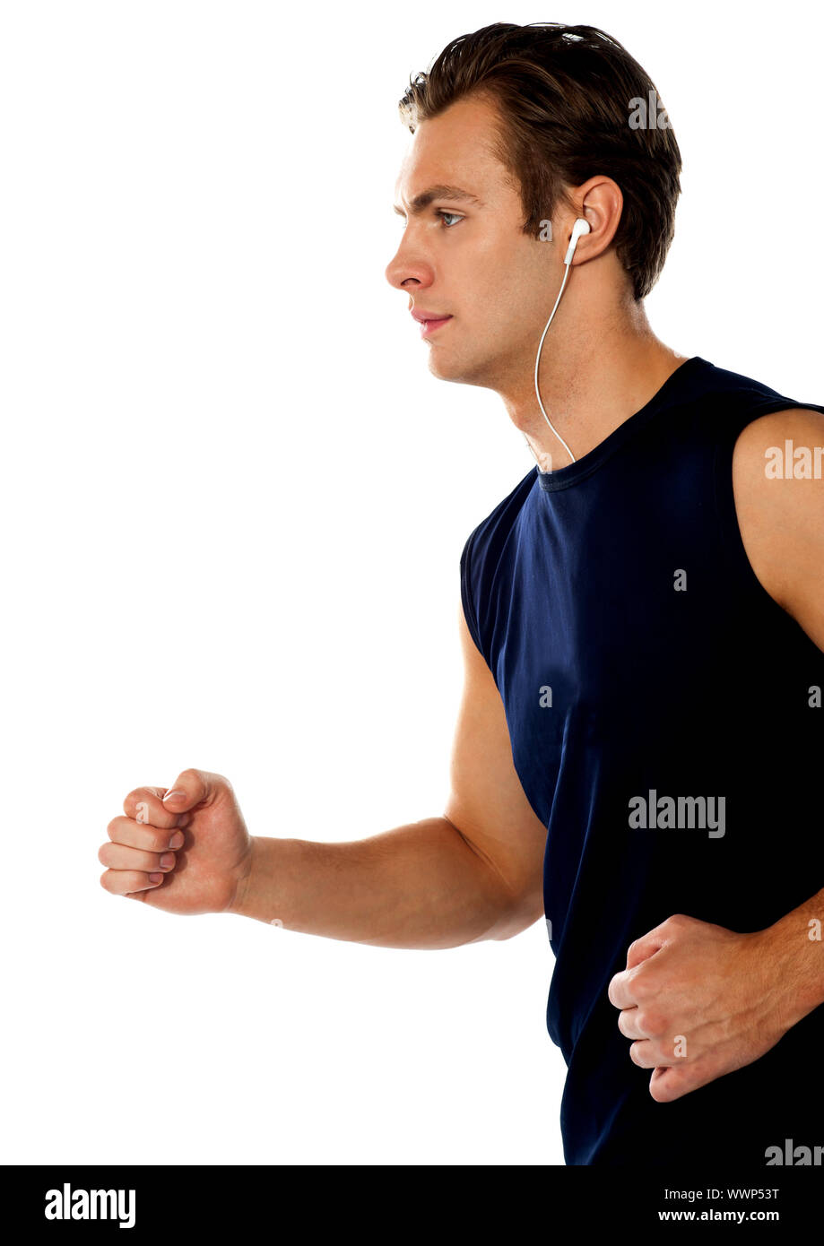 Fit athlete enjoying music in a jogging posture wearing sporty outfit ...