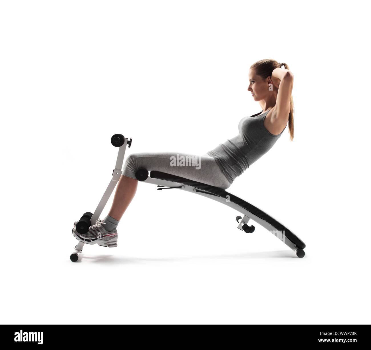 beautiful young Woman exercising abdomen muscles on bench Stock Photo ...