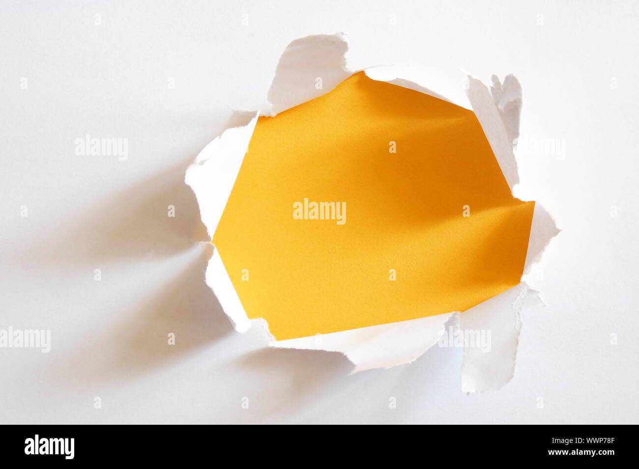 yellow hole in blank sheet paper with copyspace Stock Photo - Alamy
