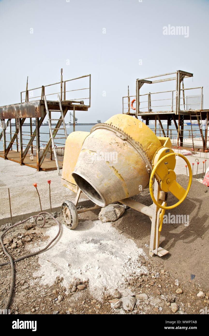 side view of a yellow working cement mixer Stock Photo - Alamy