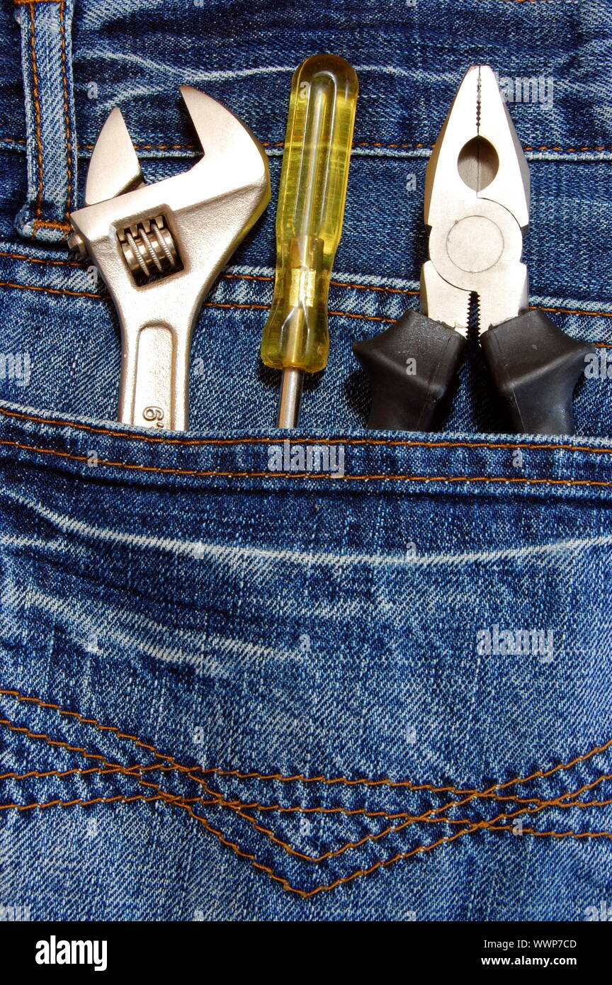 tools like caliper screwdriver and spanner in jeans pocket Stock Photo ...