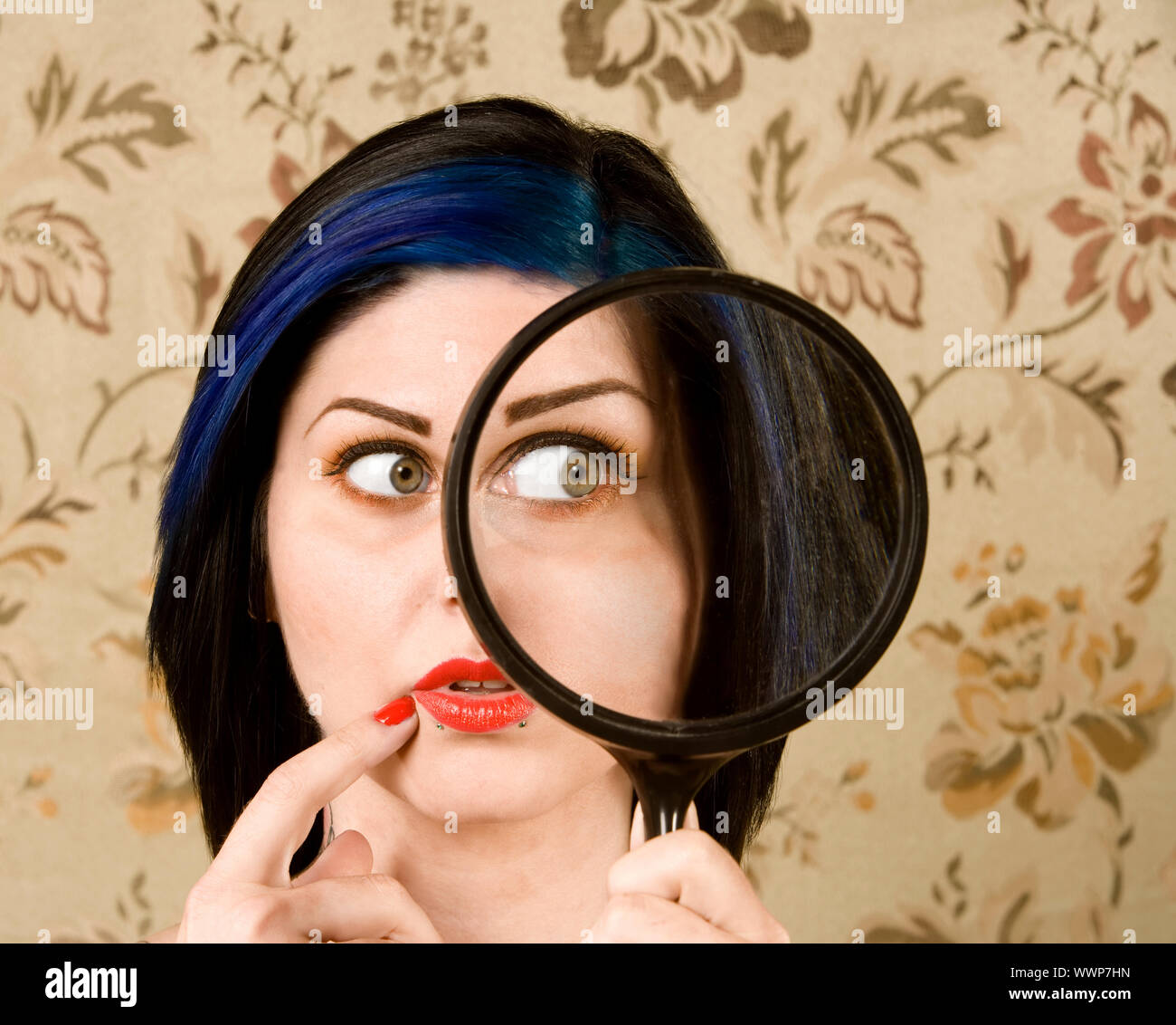 Pretty Woman Holding a magnifying Glass to her Face Stock Photo - Alamy