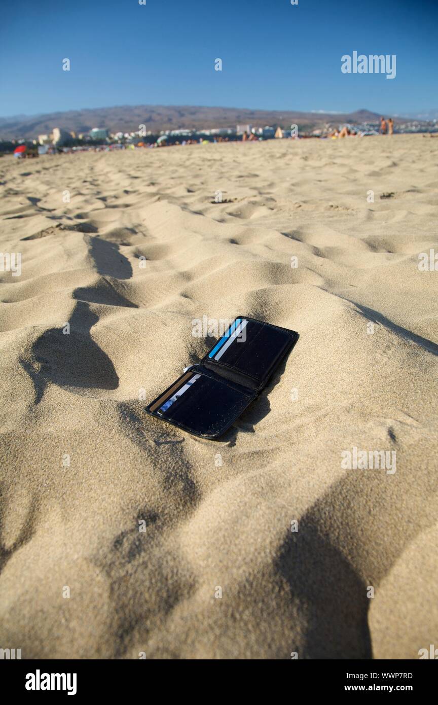 lost black leather wallet with four cards at the beach Stock Photo - Alamy