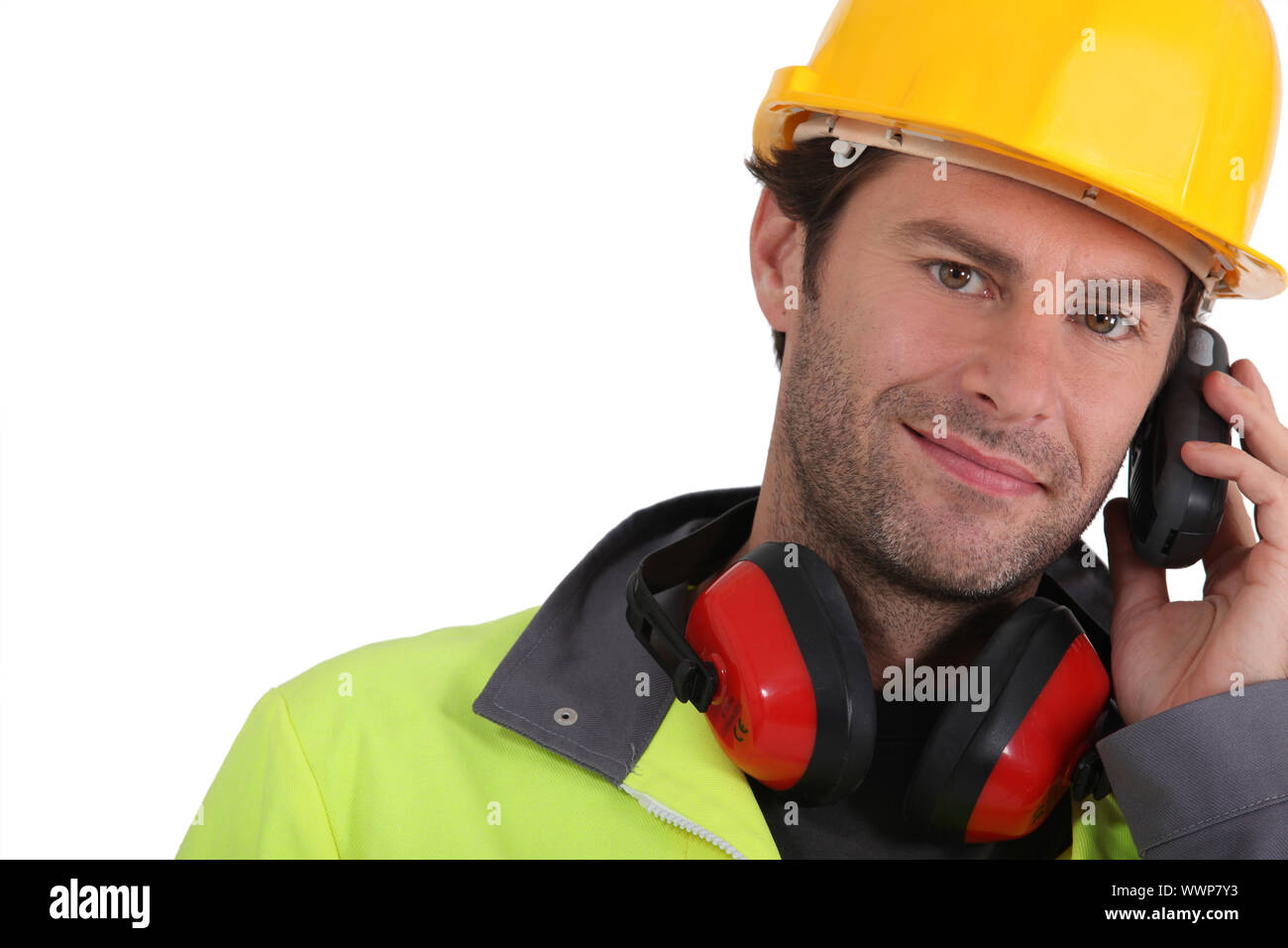 Construction worker holding radio receiver Stock Photo - Alamy