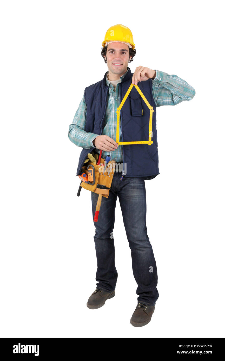 Man holding tool in shape of house Stock Photo - Alamy