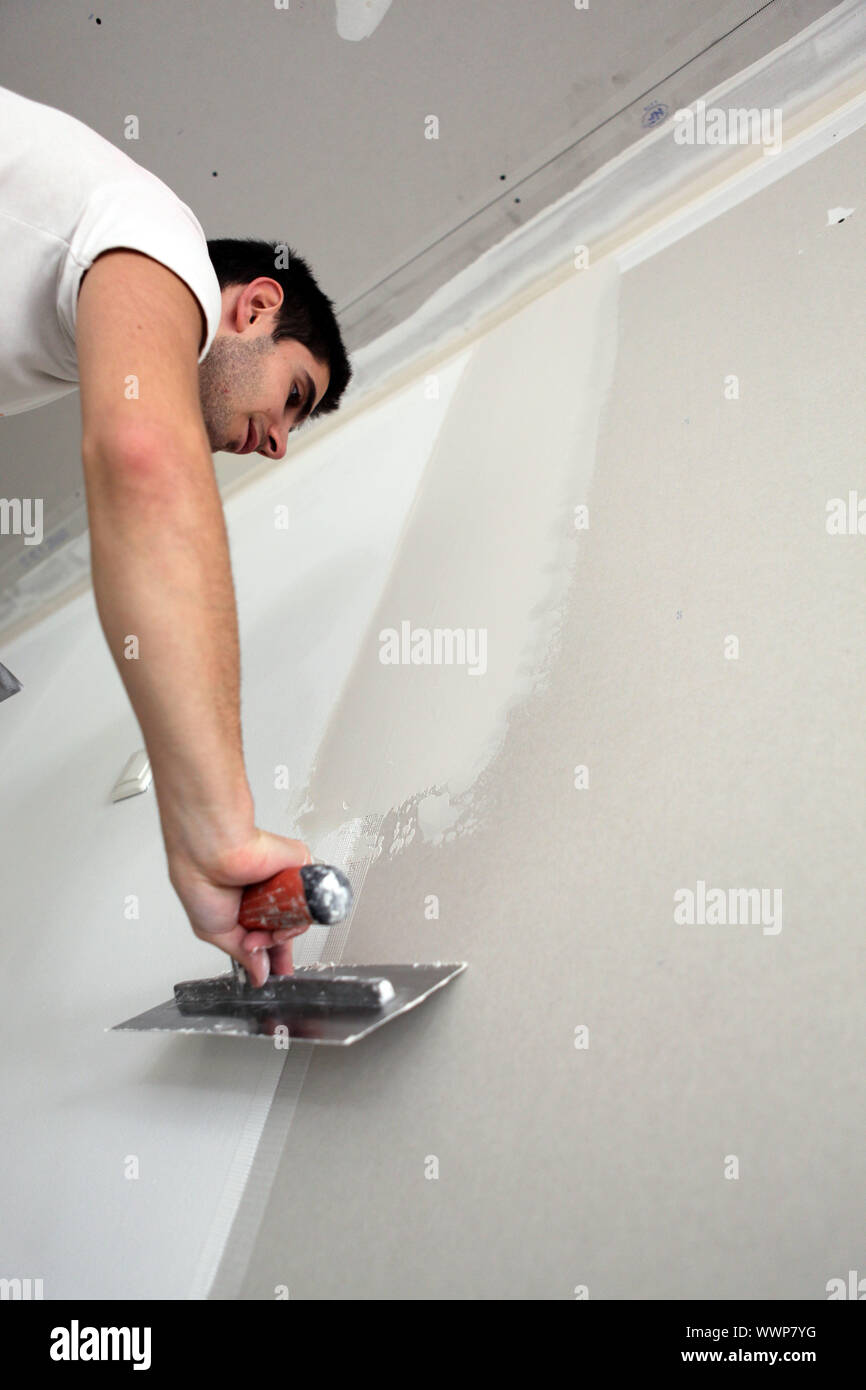 Applying plaster plasterboard wall hi-res stock photography and images ...