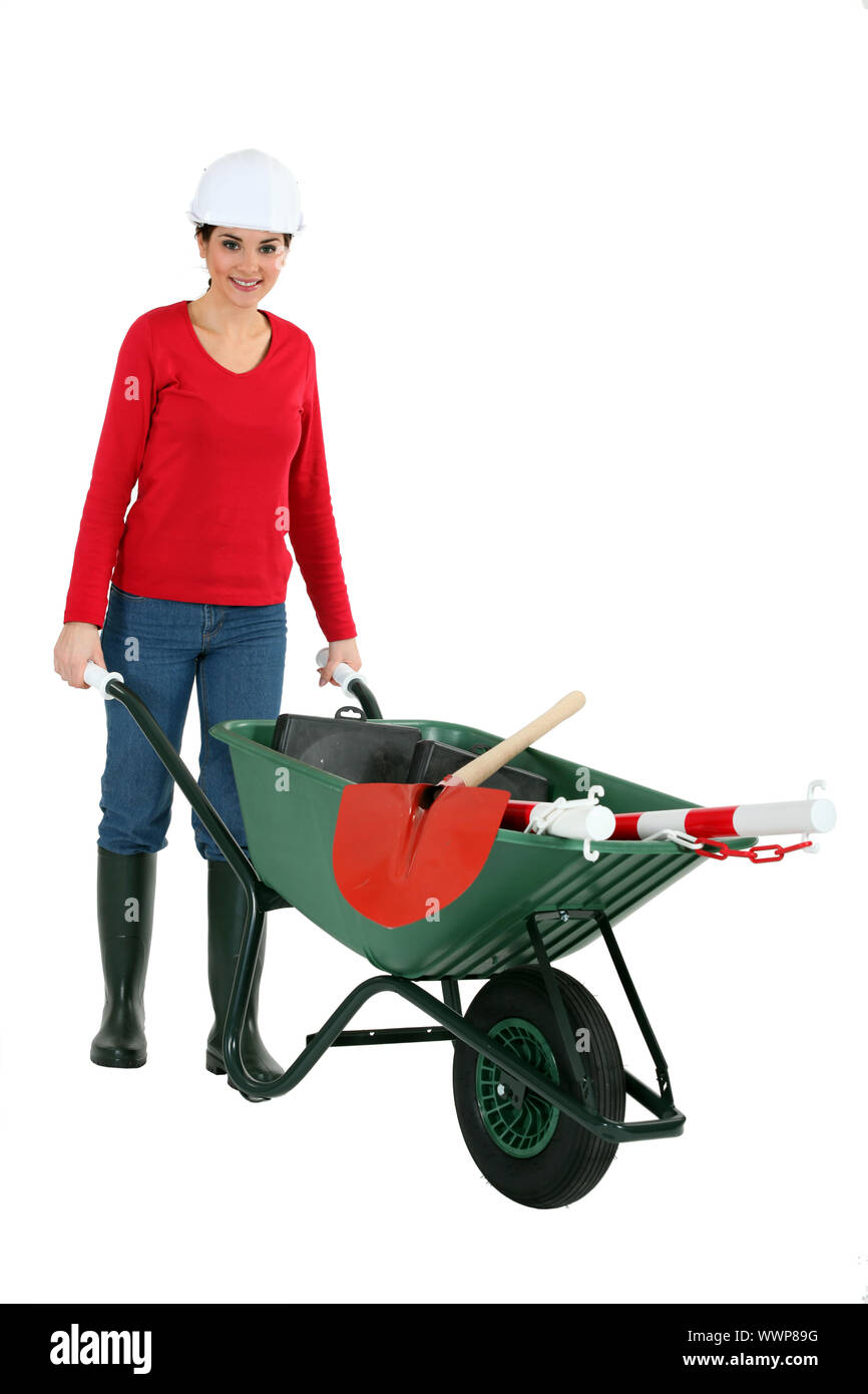 Construction Worker Pushing A Wheelbarrow High Resolution Stock ...