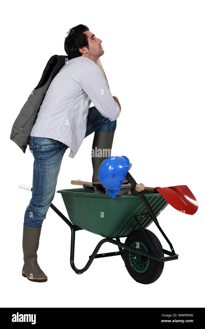 Man with wheelbarrow and spade Stock Photo - Alamy