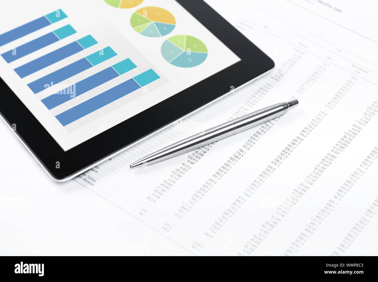 Modern workplace with digital tablet showing charts and diagram on ...