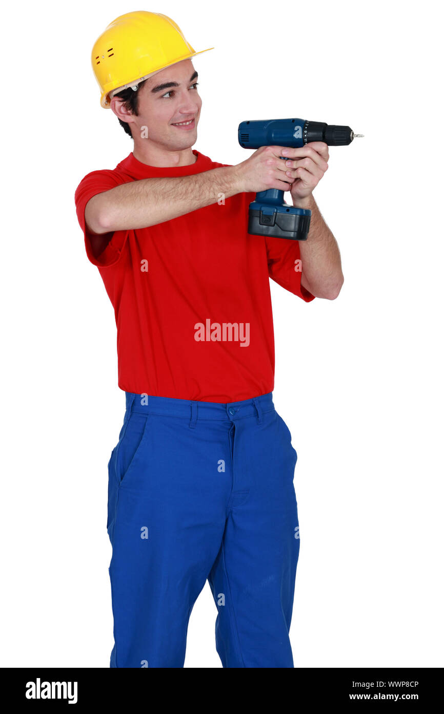 Young laborer using drill Stock Photo - Alamy