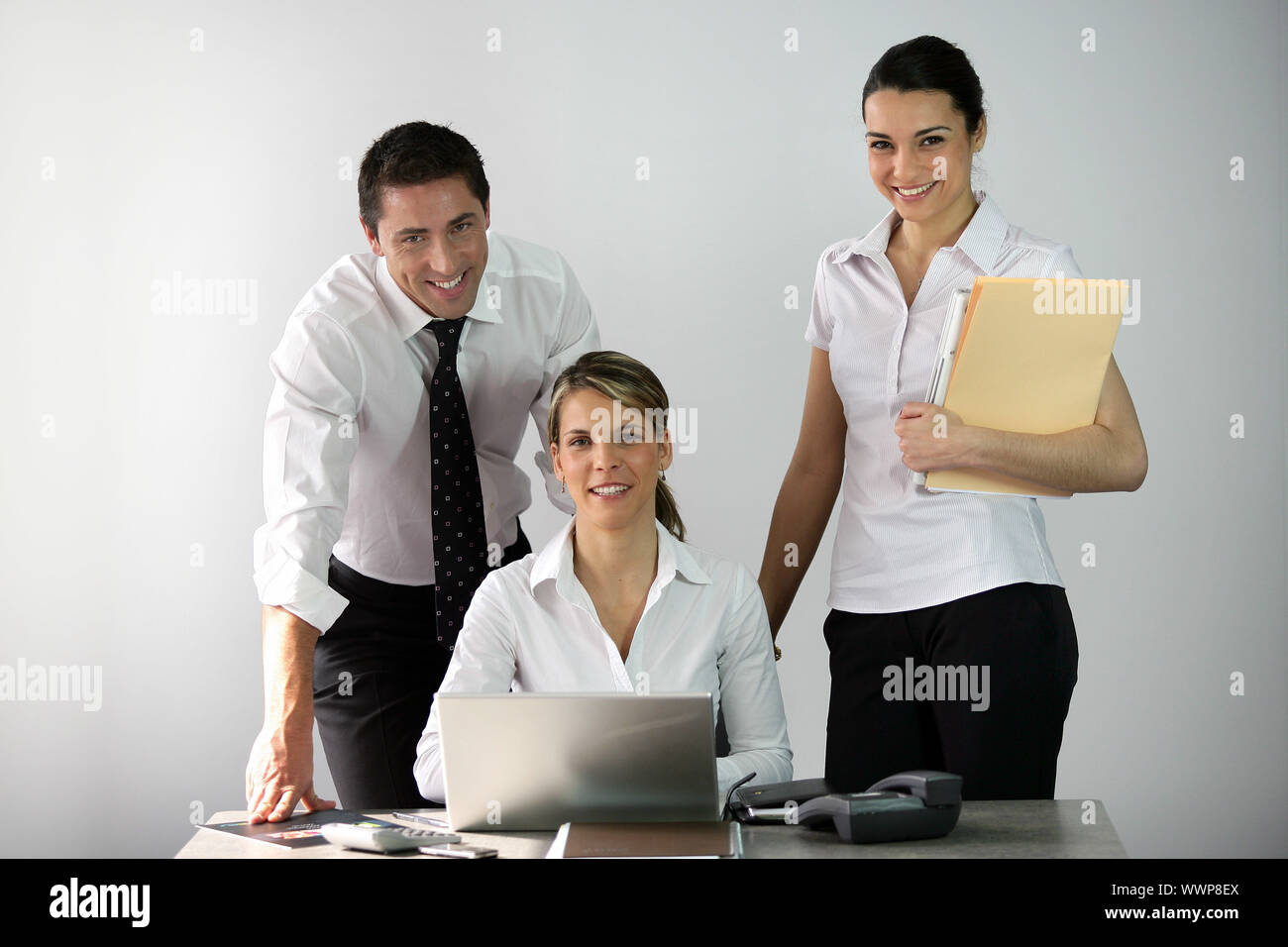 Three co-workers in office Stock Photo - Alamy