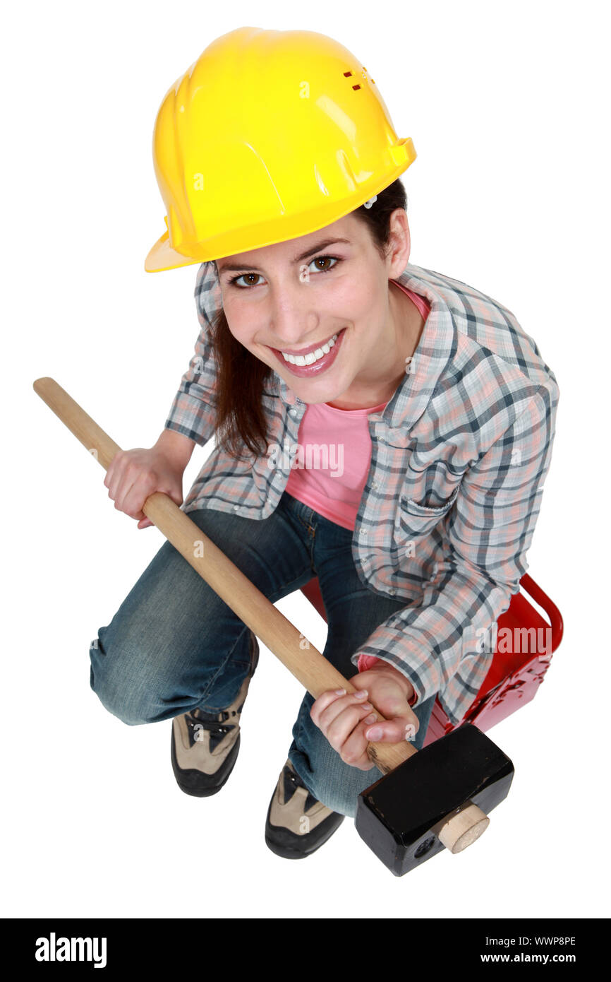 Woman with sledge-hammer sitting on tool box Stock Photo - Alamy