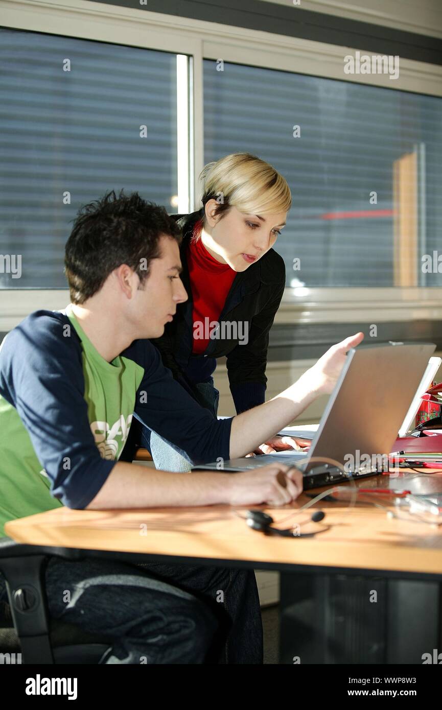 Young people at an office computer Stock Photo - Alamy