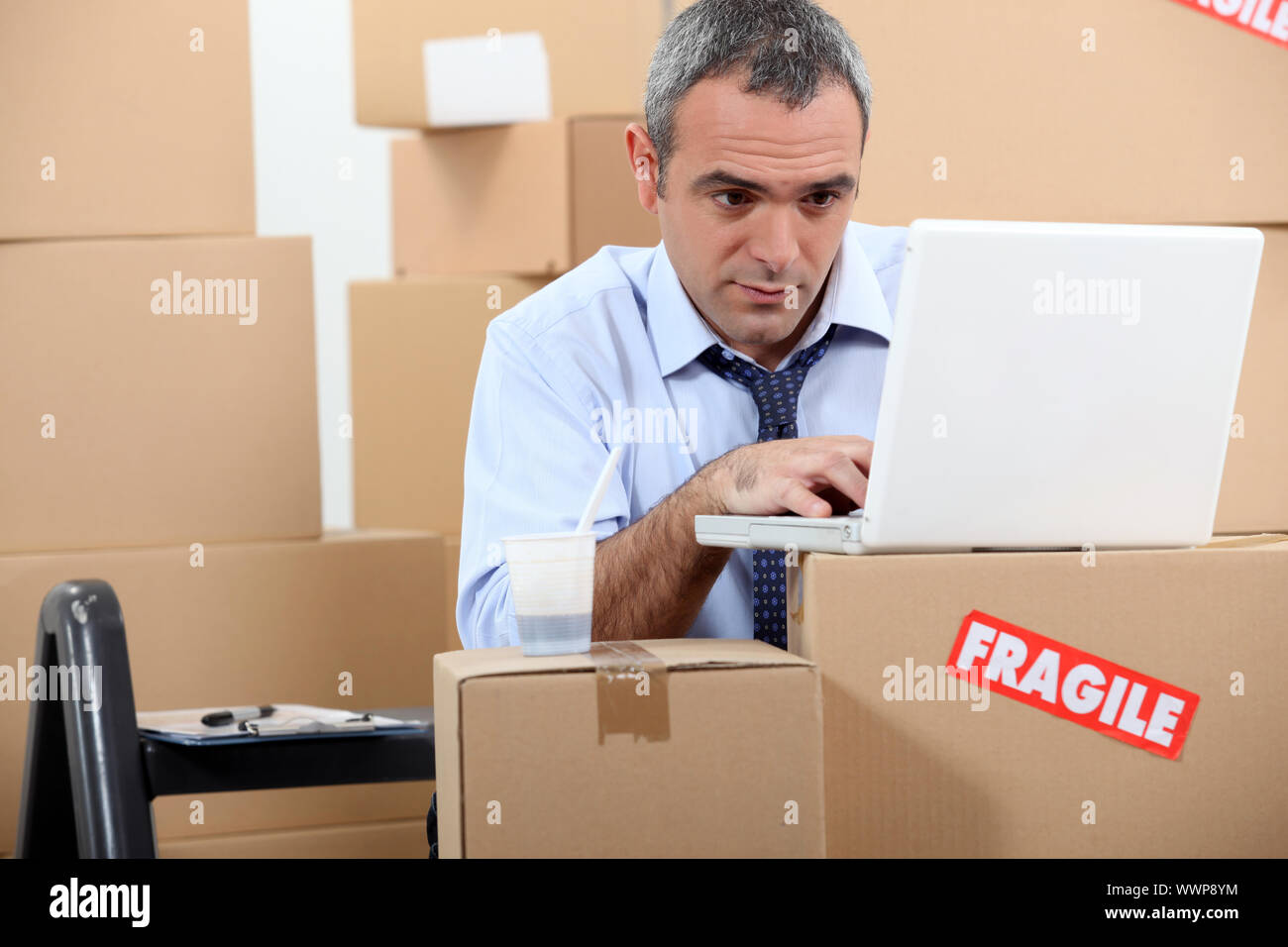 Man surrounded by boxes Stock Photo - Alamy