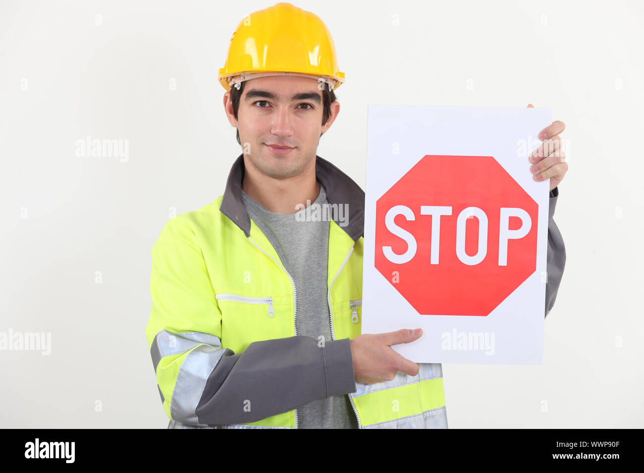Worker with stop sign Stock Photo - Alamy