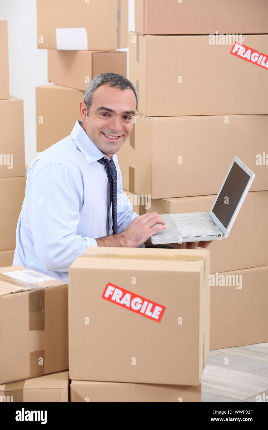 portrait of a man with cardboard boxes Stock Photo - Alamy