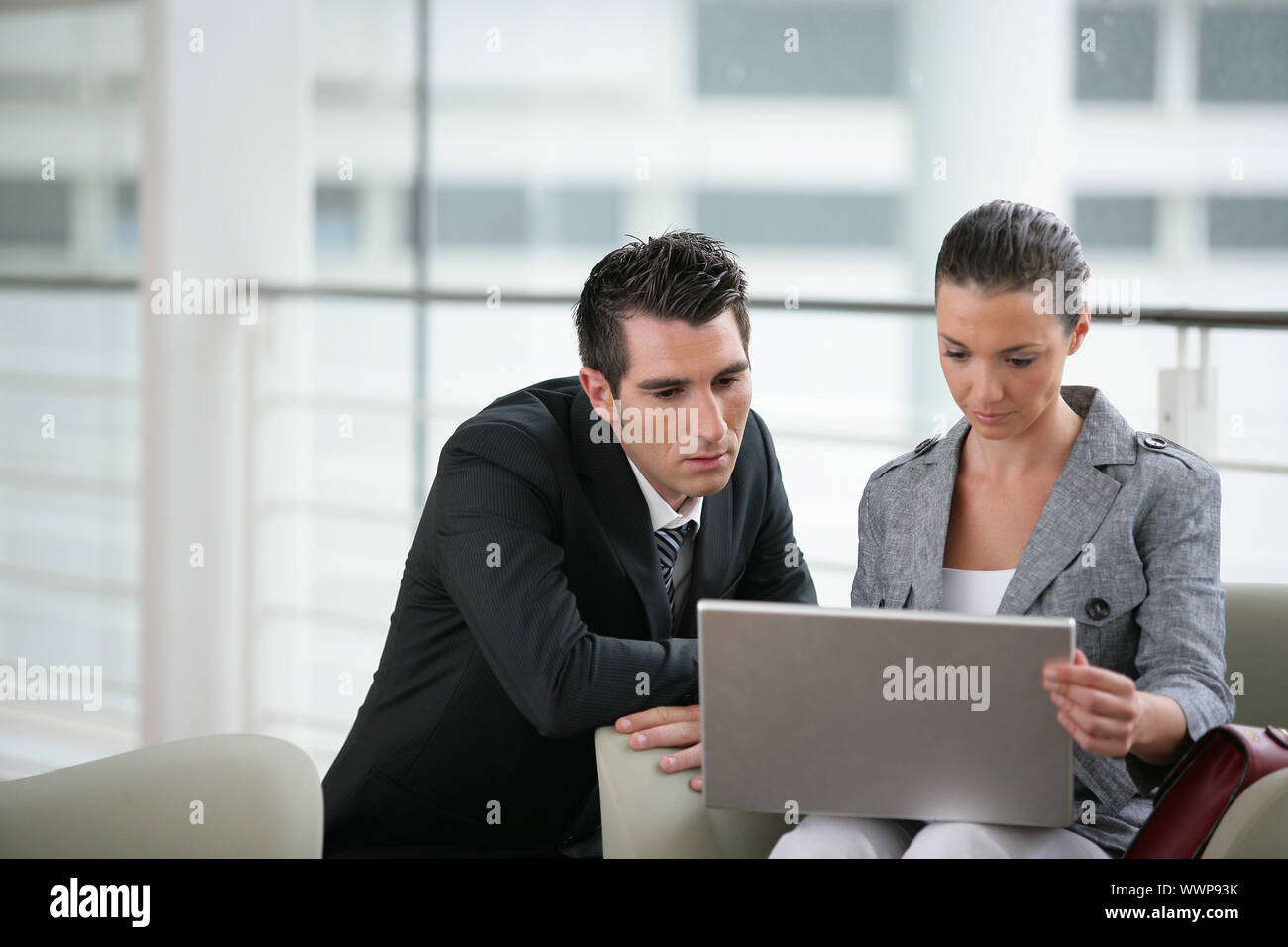 Students looking at a laptop Stock Photo - Alamy
