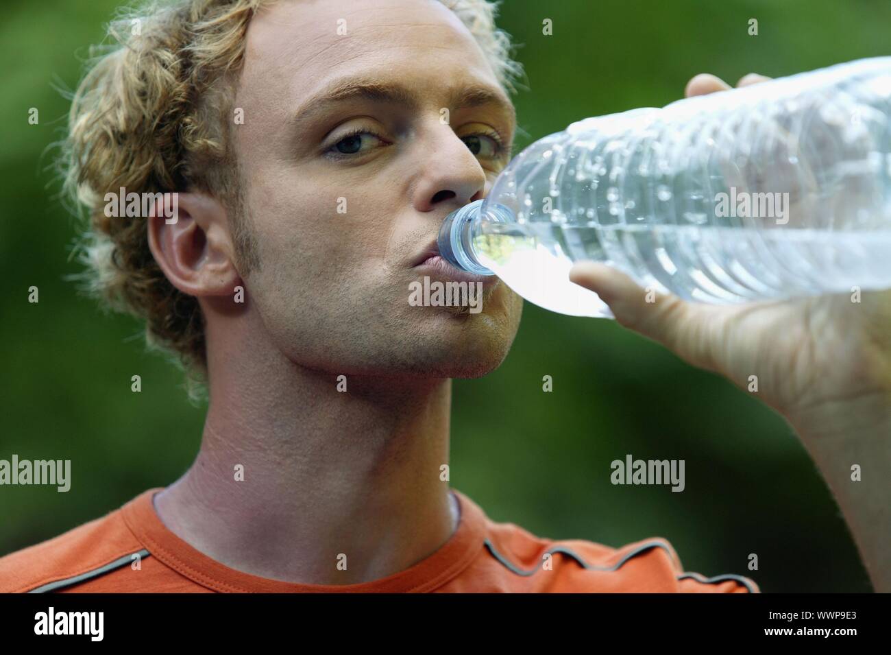 Man hydrating after outdoor run Stock Photo - Alamy