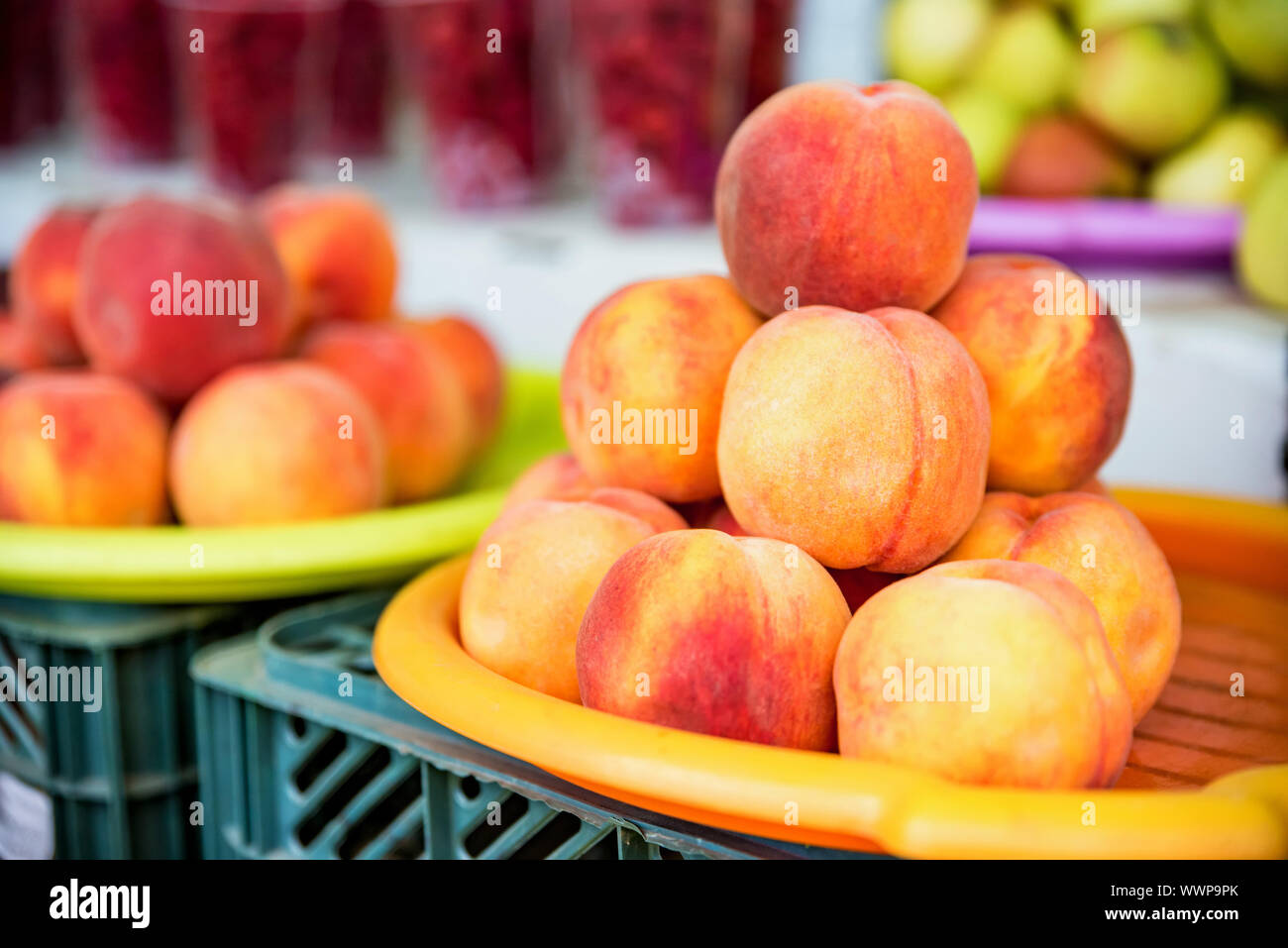 Close view of piles of fresh delicious peaches for sale in local market ...