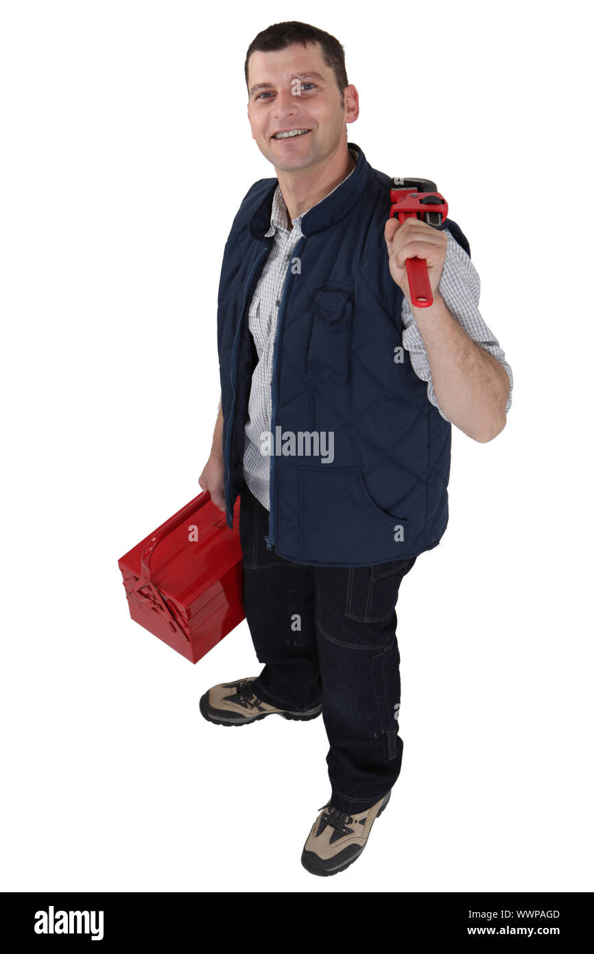 Man carrying a toolbox and a pipe wrench Stock Photo - Alamy