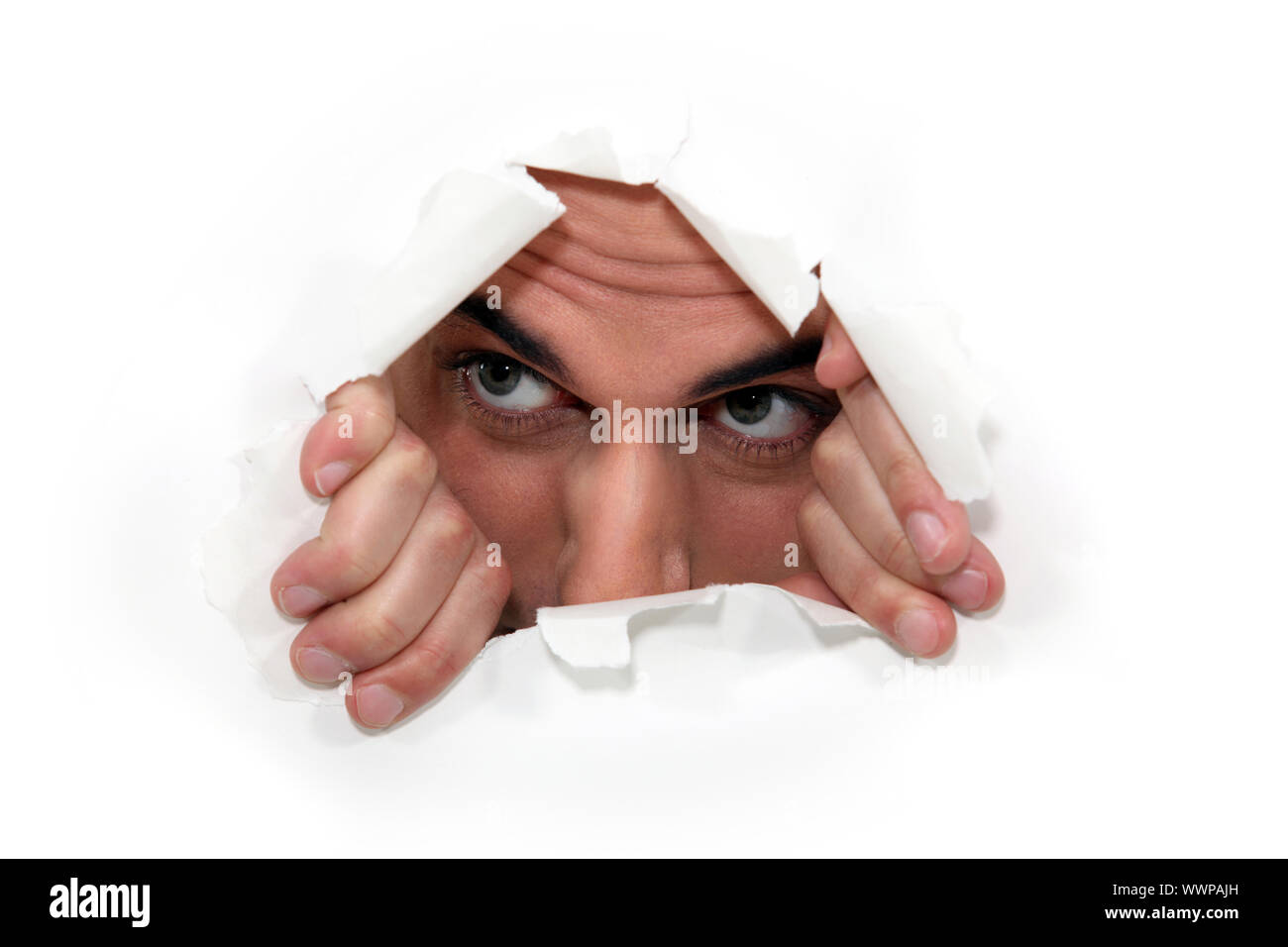Peeping through the hole in the wall Stock Photo - Alamy