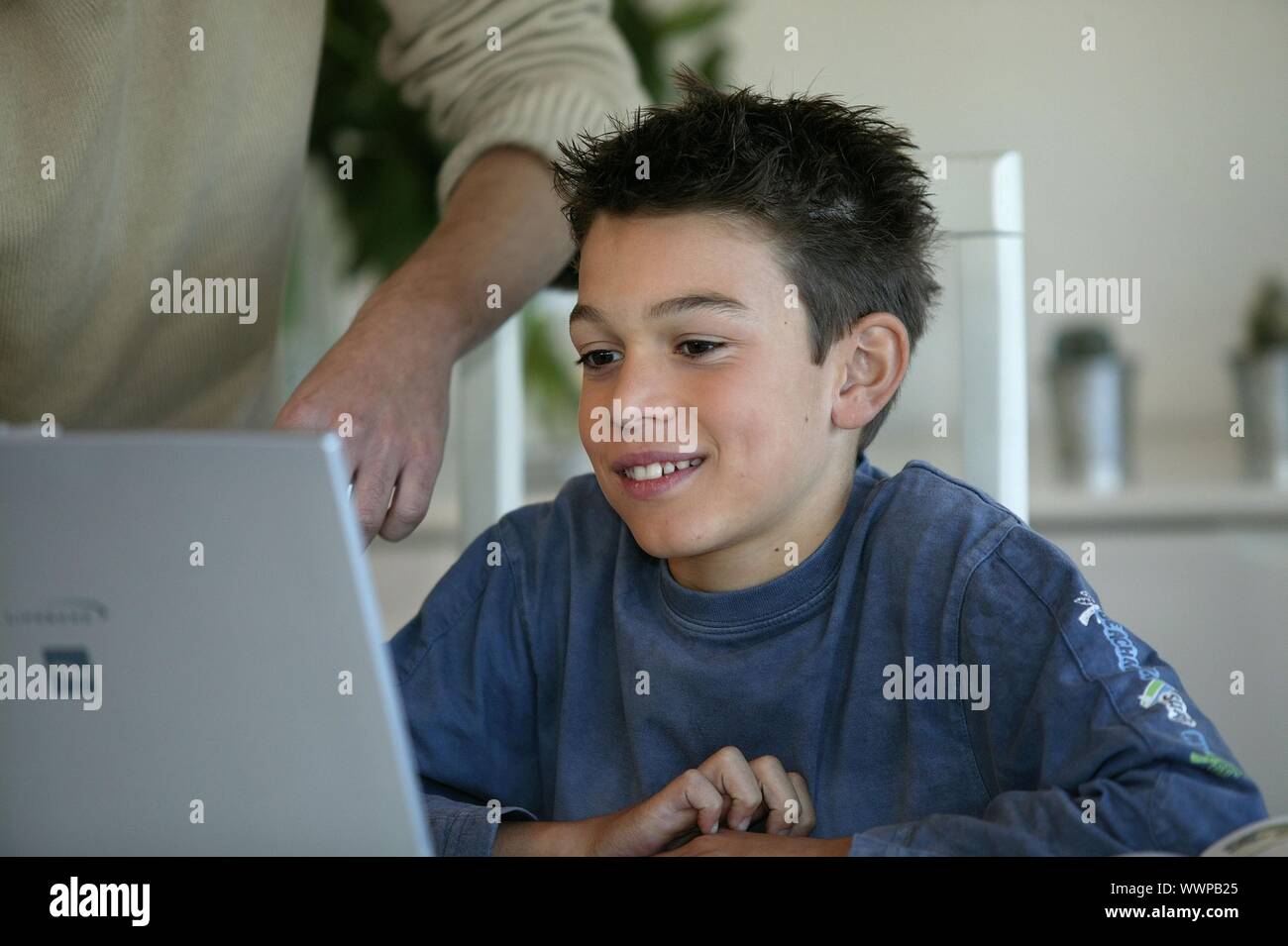 Boy using a laptop Stock Photo - Alamy