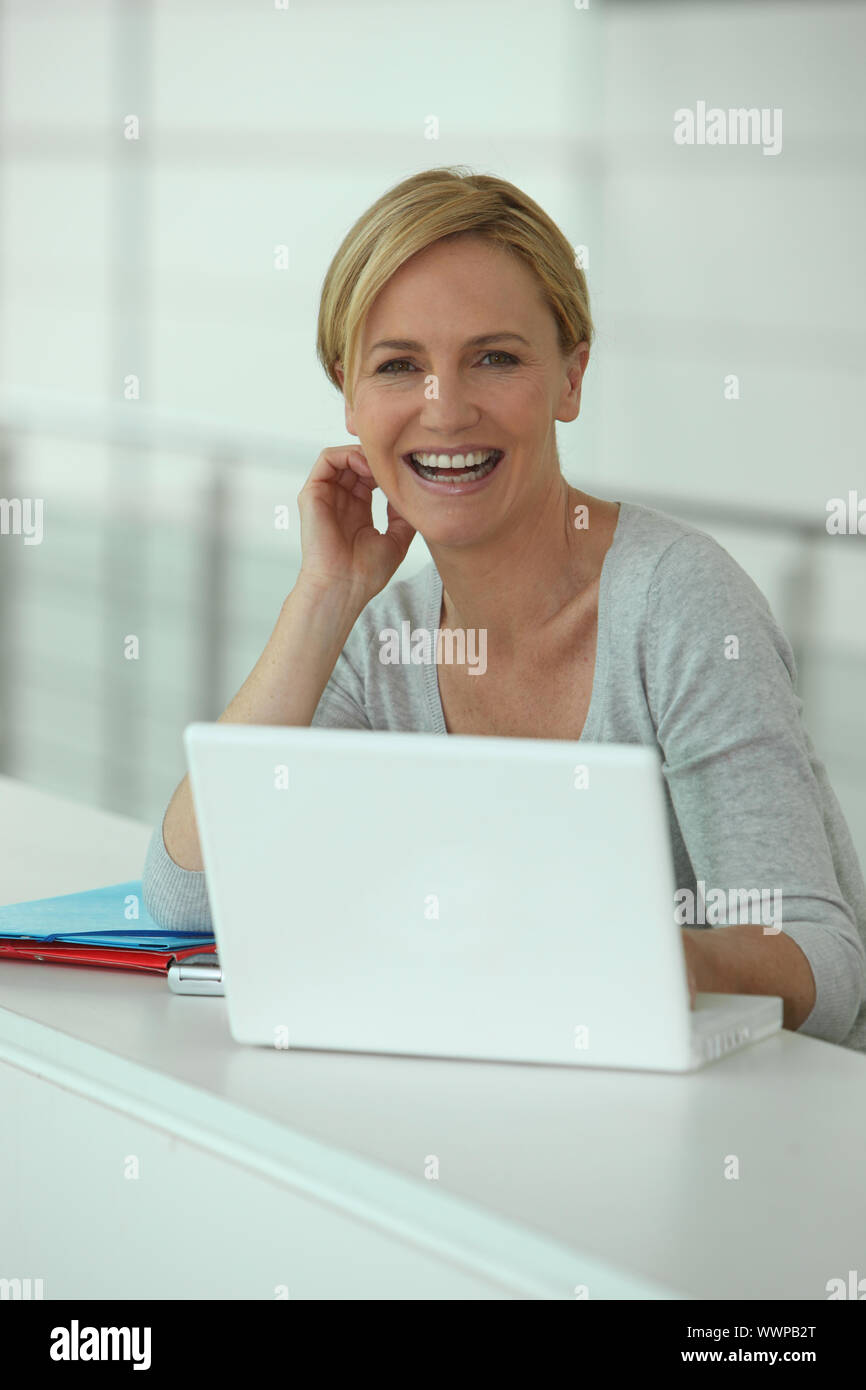 Woman laughing on laptop Stock Photo - Alamy