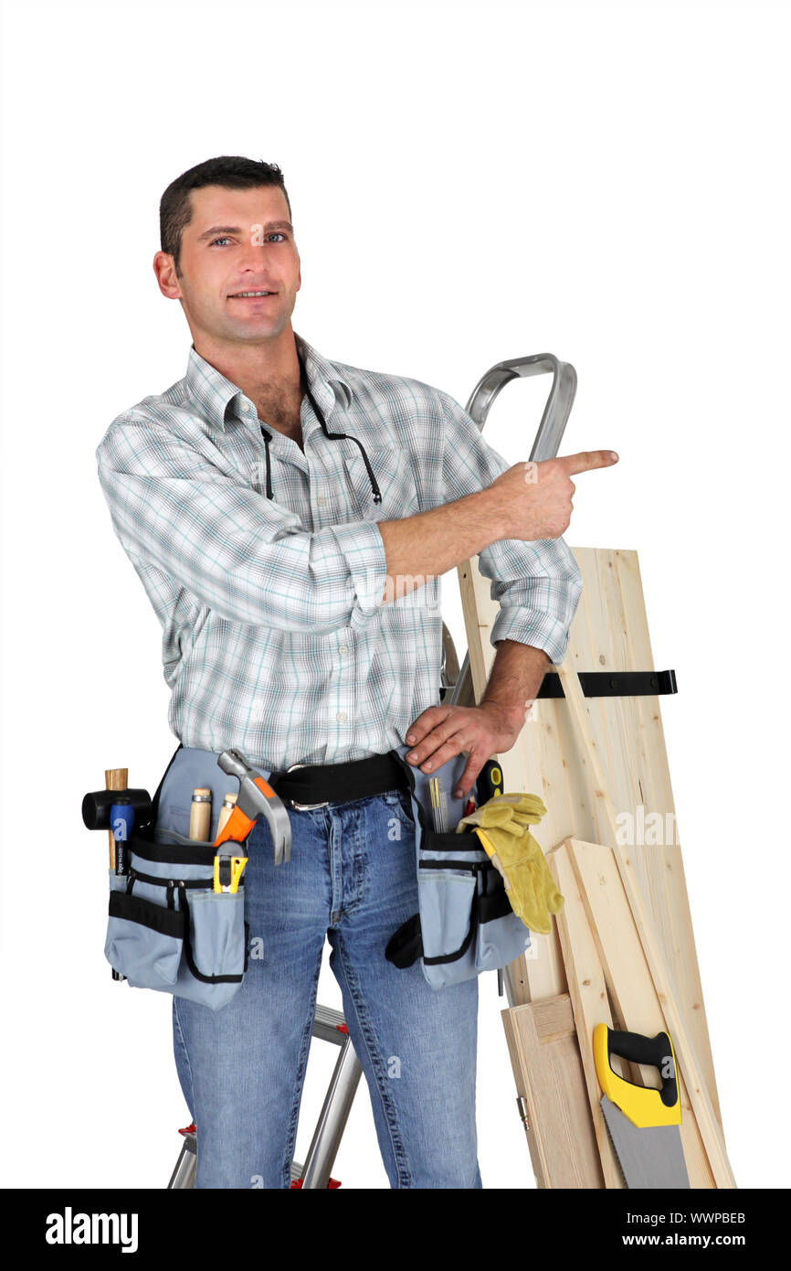 Carpenter stood with step ladder Stock Photo - Alamy