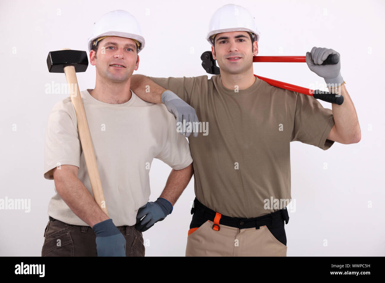 Workmen holding tools Stock Photo - Alamy