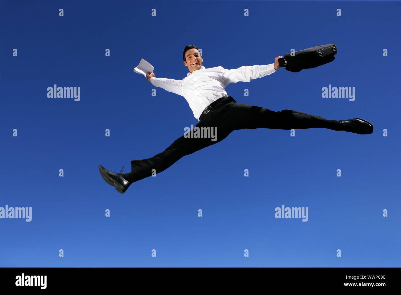 Businessman leaping through the air Stock Photo - Alamy