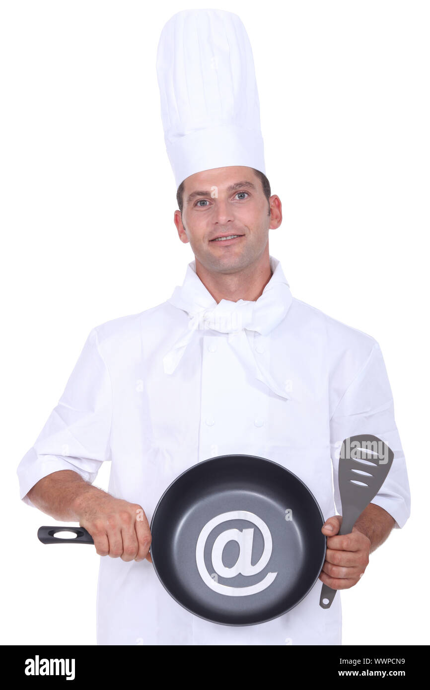 Male chef holding frying pan Stock Photo - Alamy