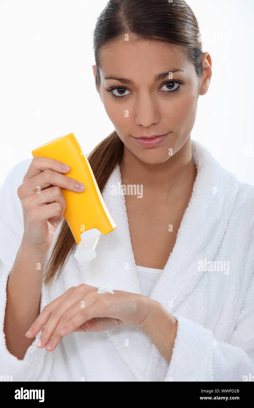 Woman putting on cream Stock Photo - Alamy