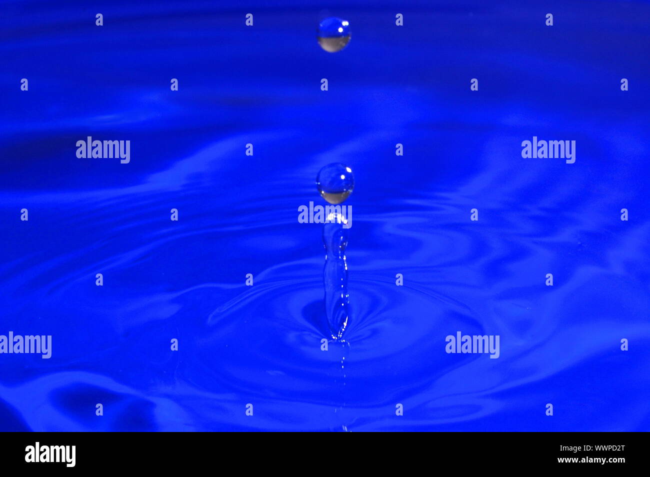 fresh water drop splashing in blue cool water Stock Photo - Alamy