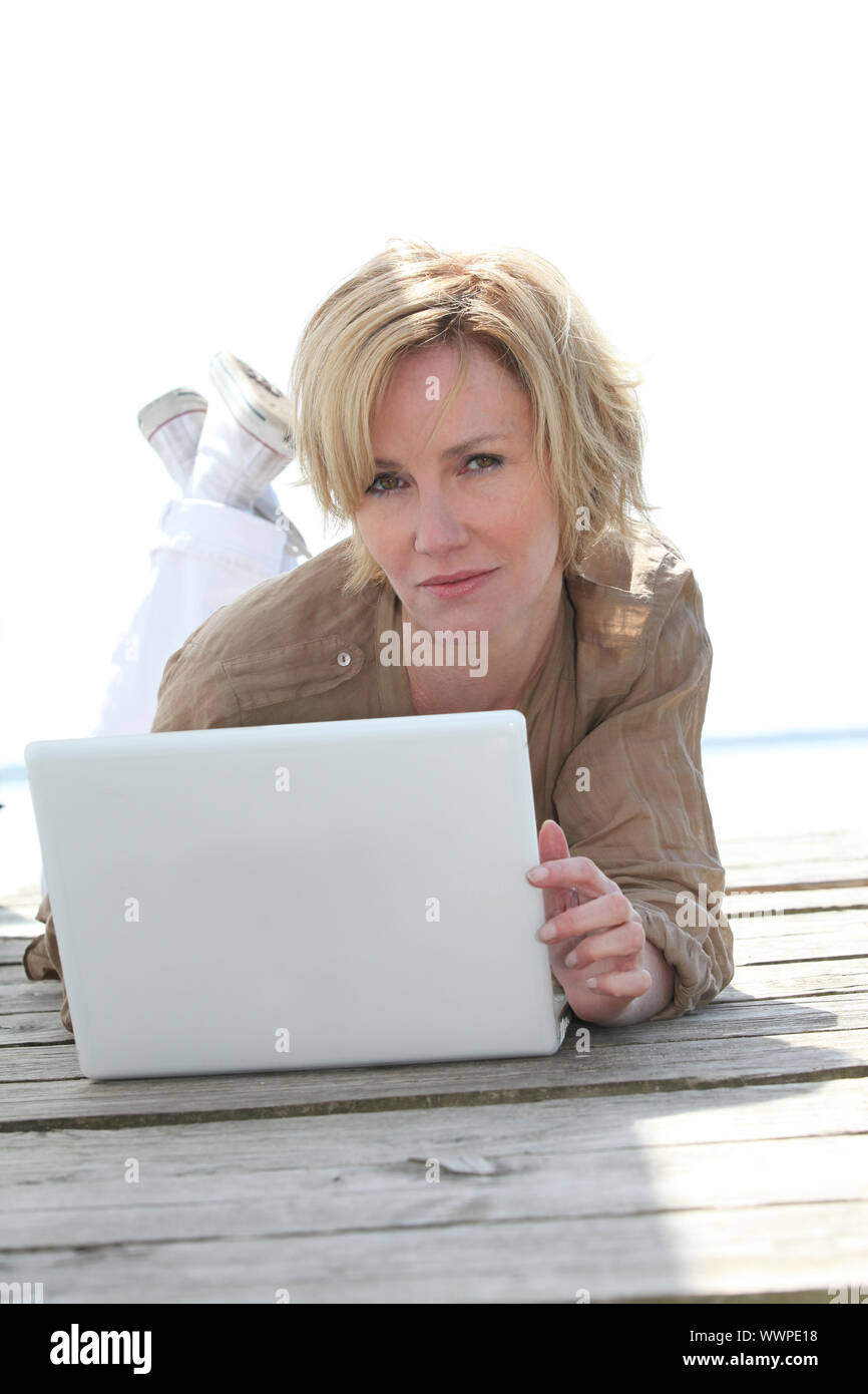 Woman on laptop outside Stock Photo - Alamy