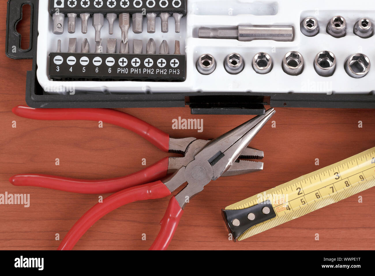 screwdriver toolbox with set of bits, pliers and measuring tape Stock ...