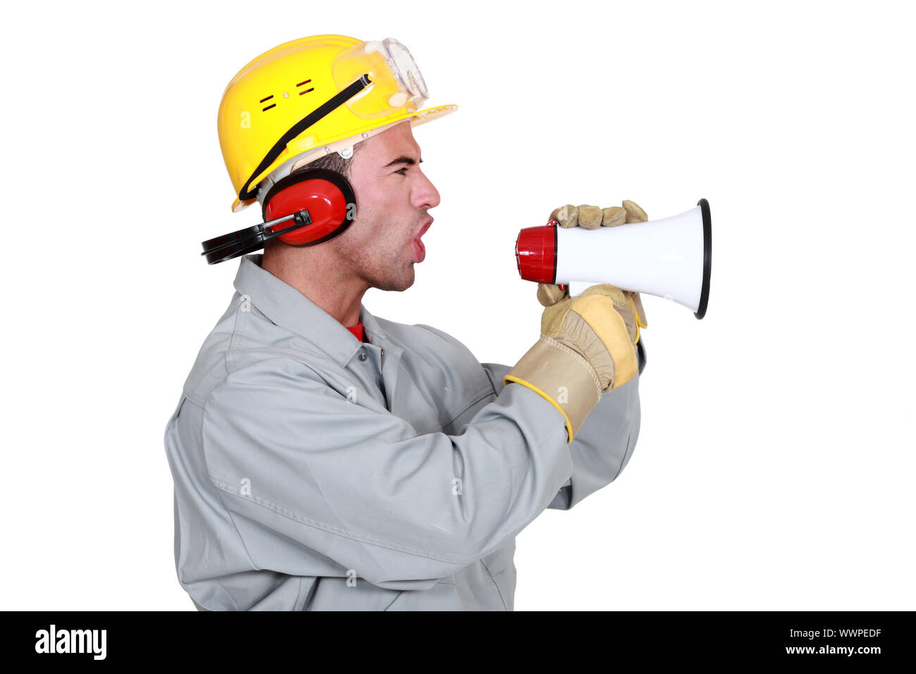 Manual worker shouting into megaphone Stock Photo - Alamy