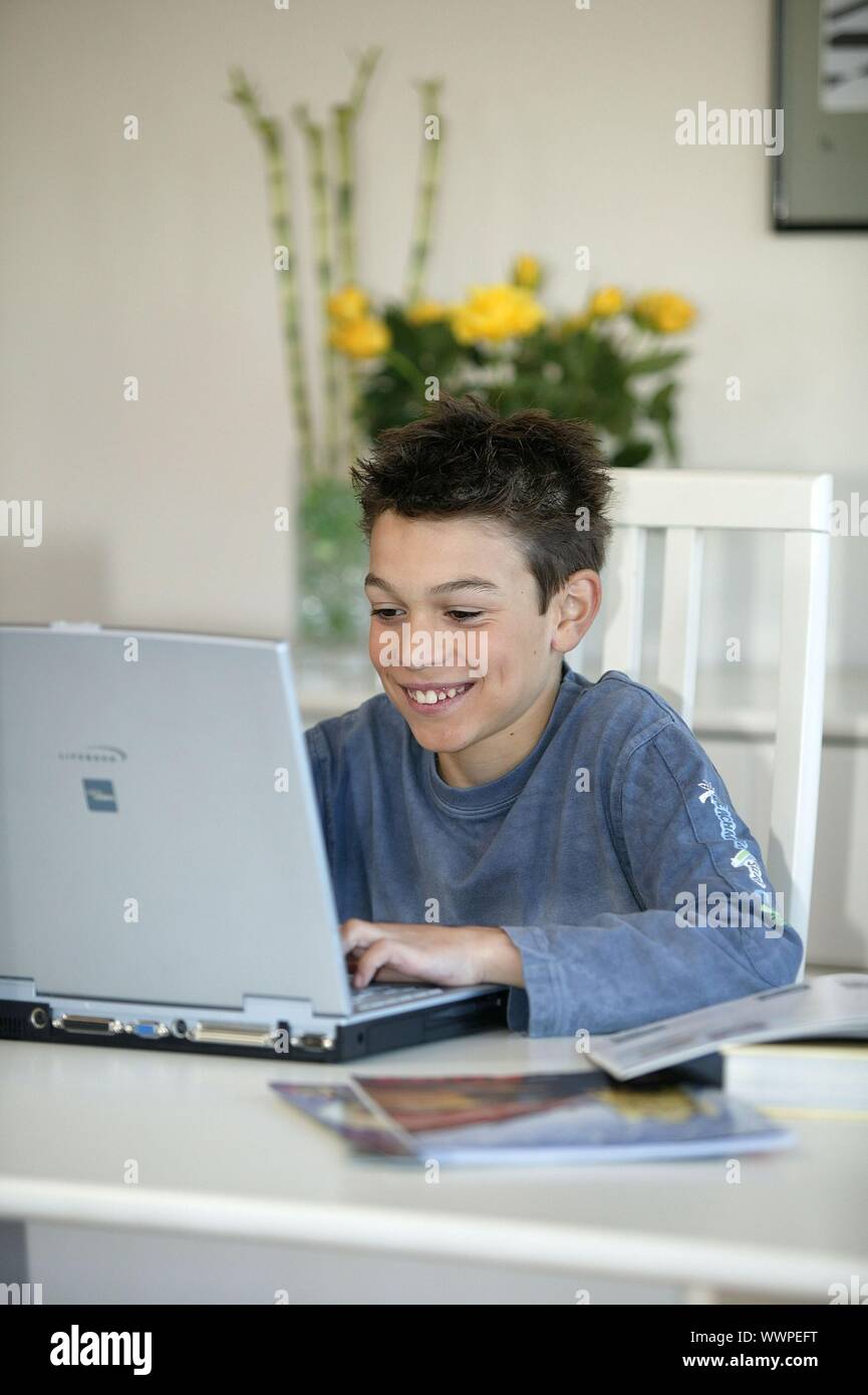 boy having fun on his laptop Stock Photo - Alamy