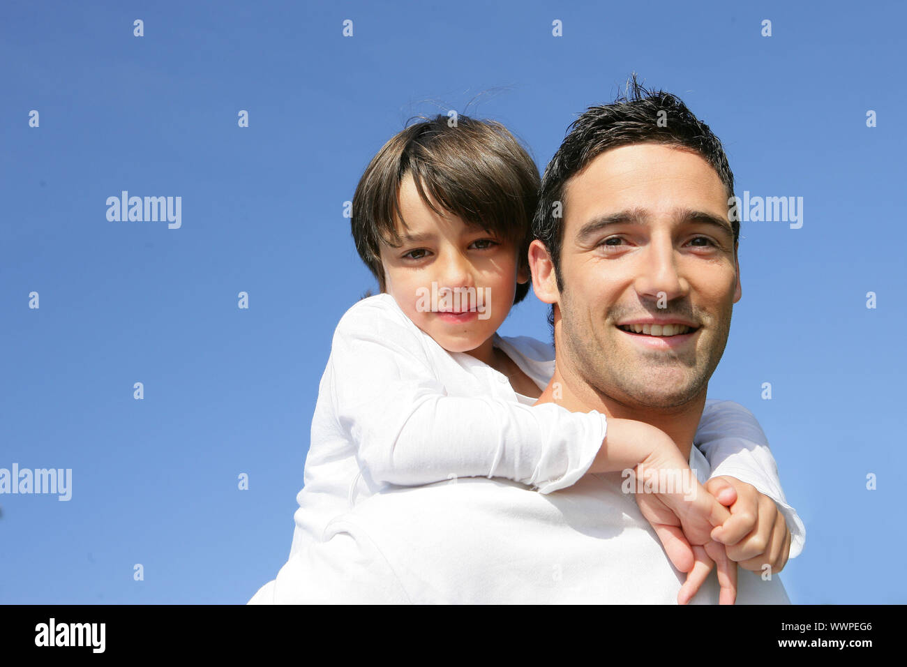 little boy on his father's back Stock Photo - Alamy